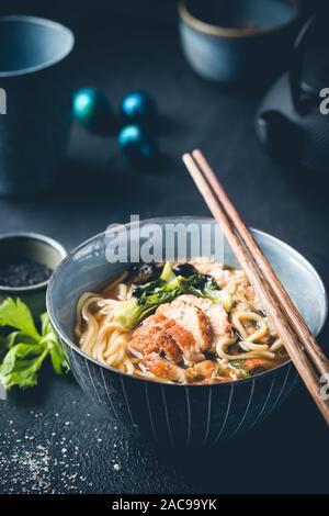 japanese soup with fried eel Yanagawa Nabe in a bowl on dark background ...
