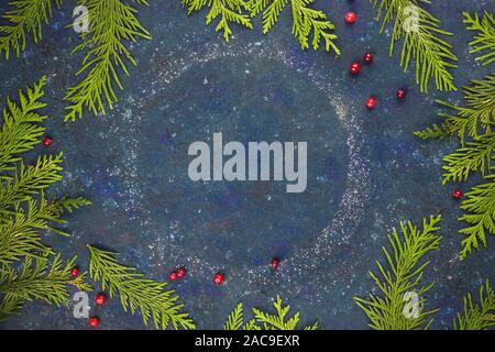 Round shape made from powdered icing sugar for baking on a blue table ...