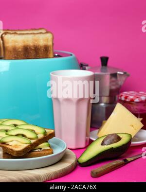 bright, fun breakfast. cyan color toaster on a pink background Stock ...