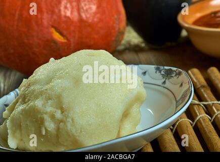 Fufu , mixing and pounding separate equal portions of cassava and green ...