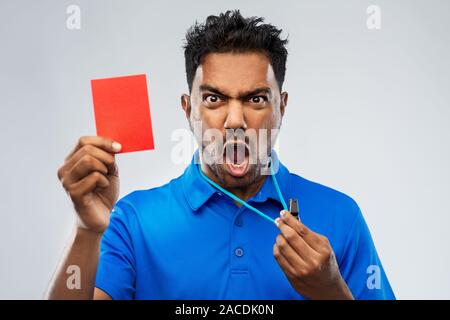 Angry football referee showing a red card and pointing with his hand ...