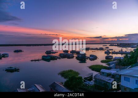 Twilight hour over the swimming houses on Lake Tefé, small town of Tefé ...