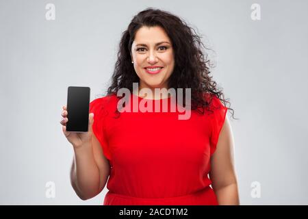 Joyful nice woman showing her smartphone to the daughter Stock Photo ...