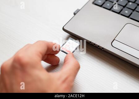 Inserting SD Card into a laptop computer. Closeup Stock Photo: 92130162 ...