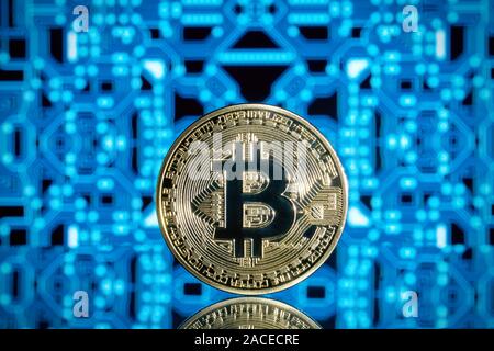 Golden bitcoin on blue background Stock Photo - Alamy