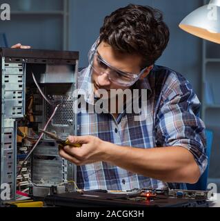 Man repairing computer desktop with pliers Stock Photo - Alamy