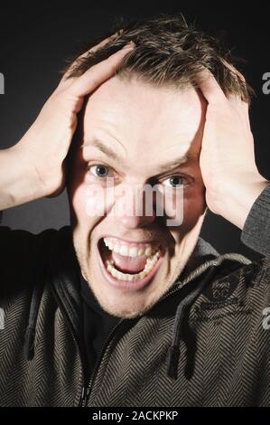 Portrait of young man horrified Stock Photo - Alamy