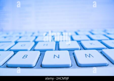The keyboard of a computer in front of a screen. Data processing and ...