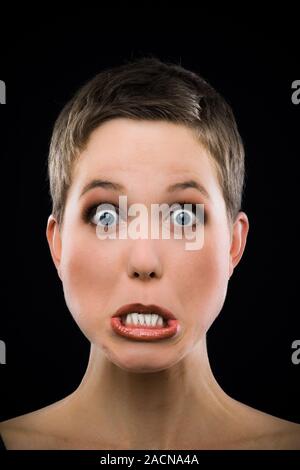 Portrait young woman, gurning Stock Photo - Alamy