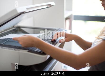 Businesswoman Using Photocopy Machine In Office Stock Photo - Alamy