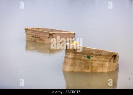 white plastic boxes floating in the water Stock Photo - Alamy