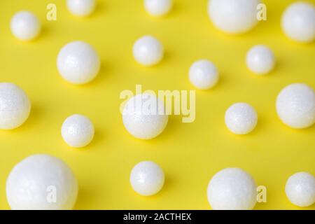 Bubbles made of styrofoam balls on yellow background minimal creative ...