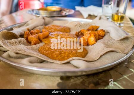 Various vegan curries and dishes served on injera (Ethiopian sourdough ...