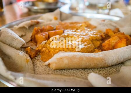 Various vegan curries and dishes served on injera (Ethiopian sourdough ...