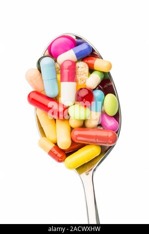 Many tablets on spoon Stock Photo - Alamy