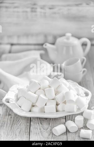 Marshmallows on plate on light background Stock Photo - Alamy