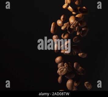 Flying coffee beans over dark background. Close-up Stock Photo - Alamy