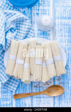 Raw Italian spaghetti heap with cheese and vegetables Stock Photo - Alamy