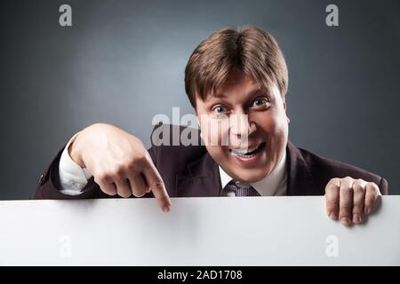 Adult businessman pointing at blank space Stock Photo - Alamy