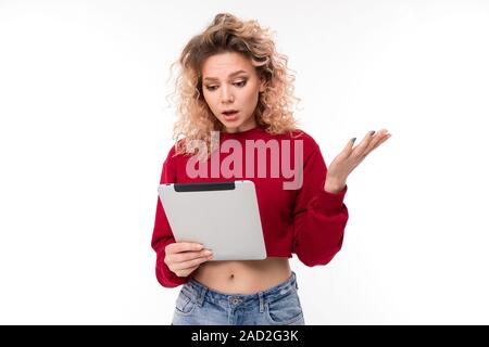 European girl reads messages on a tablet on a white background Stock ...