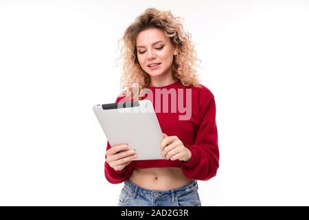 European girl reads messages on a tablet on a white background Stock ...