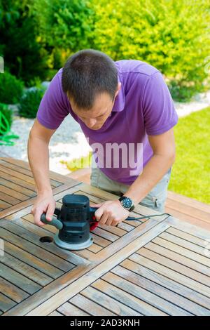 Old man - carpenter working with electric sander Stock Photo - Alamy
