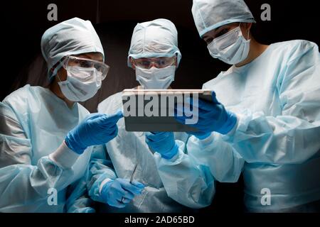Male medical assistant with tablet computer smiling on white background ...