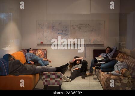 software developers sleeping on sofa in creative startup office Stock ...