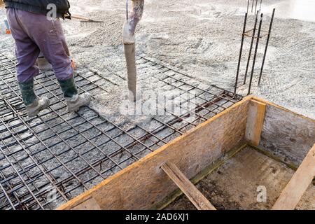 pipe with cement filling the foundation slab of a building under ...