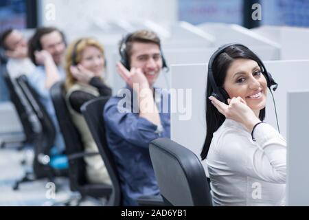 Call center. Group of operators at work. Focus on young brunette woman. Business concept Stock ...