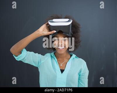 Happy girl getting experience using VR headset glasses of virtual ...