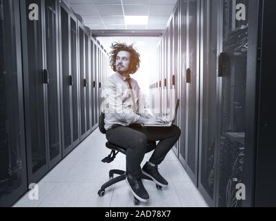 Laptop, server room and technician people problem solving in database ...