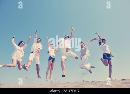happy people group have fun and running on beach Stock Photo - Alamy