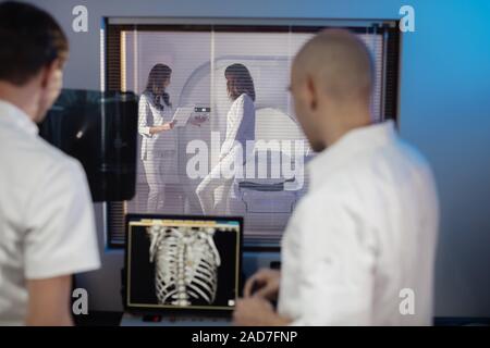 Patient undergoes an MRI diagnostic procedure using modern equipment ...