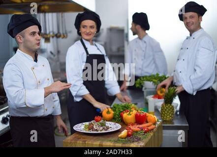 team cooks and chefs preparing meals Stock Photo - Alamy