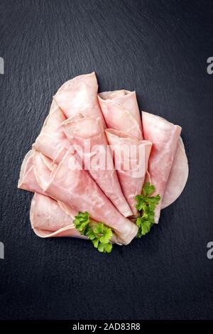 slices of ham with parsley Stock Photo - Alamy