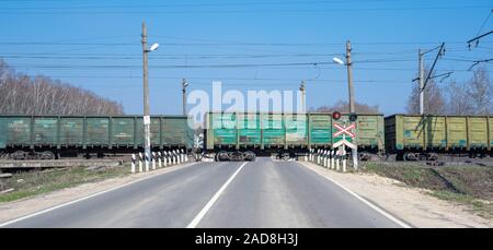 Railway crossing without barrier. A road sign depicting an old black ...