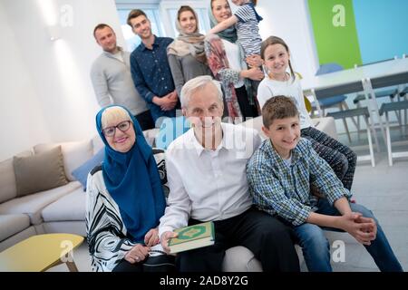 several generations portrait of happy modern muslim family before iftar ...