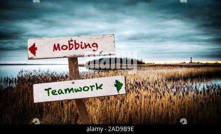 Street Sign to Teamwork versus Mobbing Stock Photo - Alamy