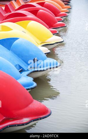 Colourful boats in shape of dolphins Stock Photo - Alamy