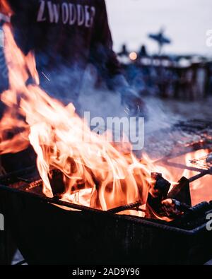 Cooking fish on the fire. Tourist fire, trivet, and two pot that cooked ...