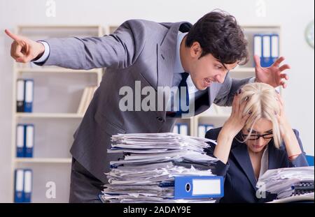 The angry irate boss yelling and shouting at his secretary employee ...