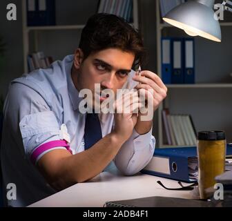 Employee relieving stress from overtime with drugs narcotics Stock ...