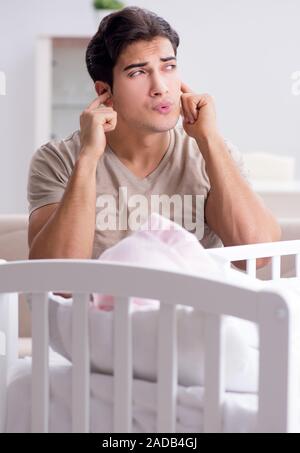 Young father dad frustrated at crying baby Stock Photo - Alamy