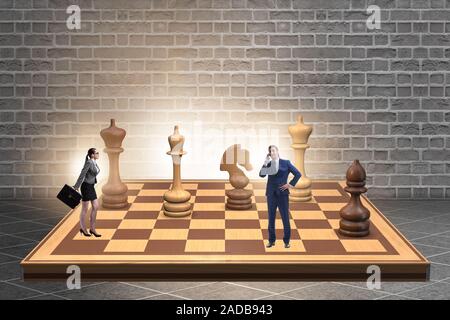 The businessman in large chess board in strategy concept Stock Photo ...