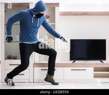 Burglar Breaking Into House And Stealing Television Stock Photo - Alamy