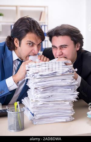 The two male colleagues unhappy with excessive work Stock Photo - Alamy