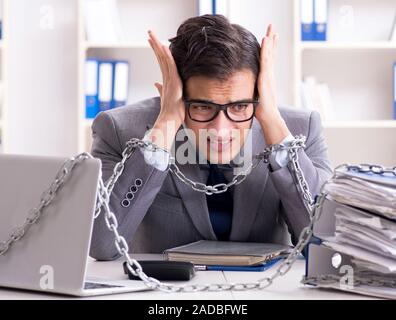Busy employee chained to his office desk Stock Photo - Alamy
