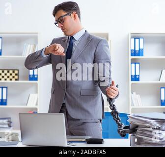 Office employee executive is chained to office desk and chair Stock ...