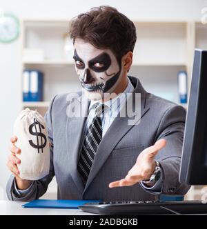 Businessmsn with scary face mask working in office Stock Photo - Alamy